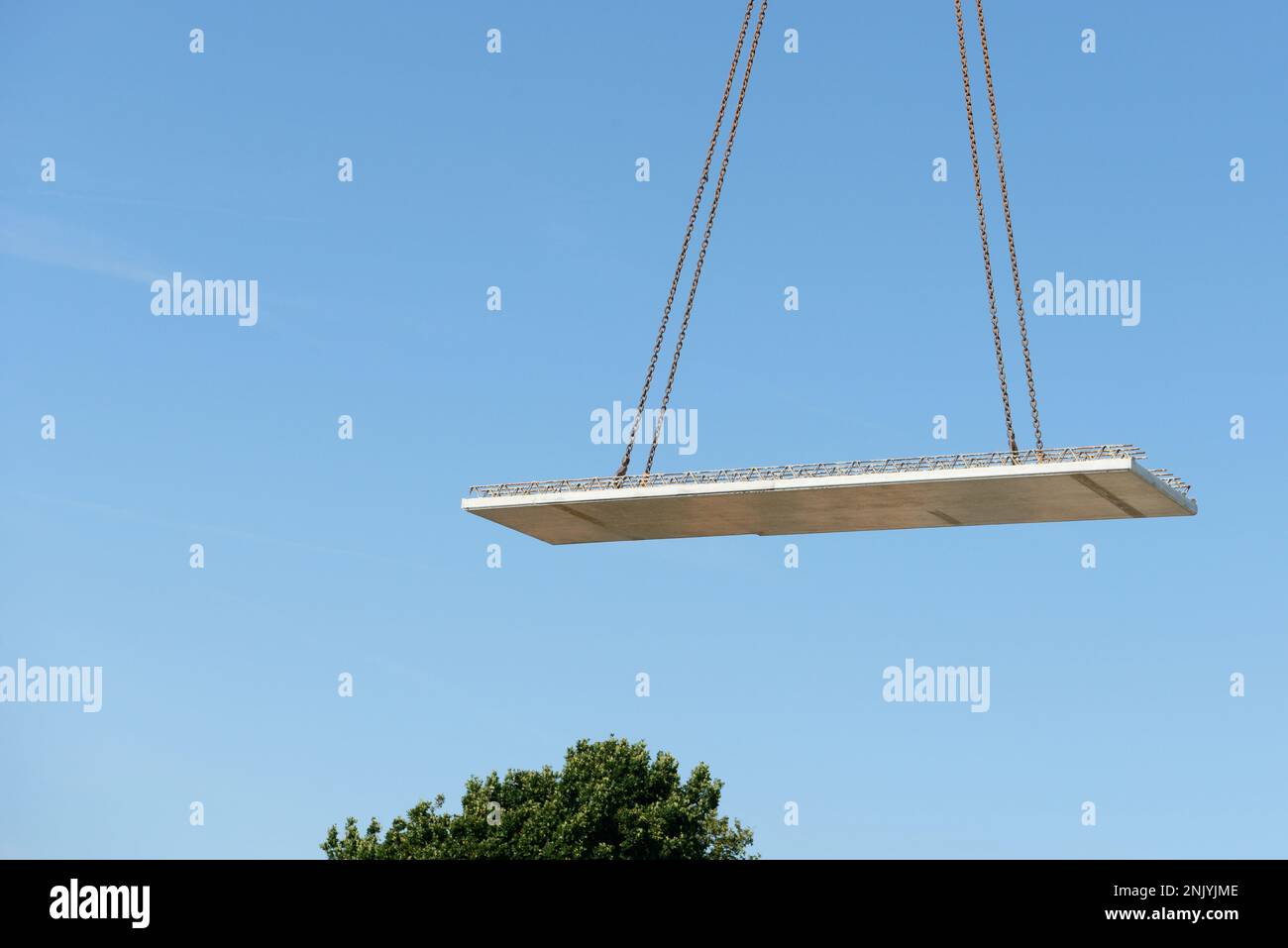 Precast Floor Slab flies through the air in front of bue sky Stock ...