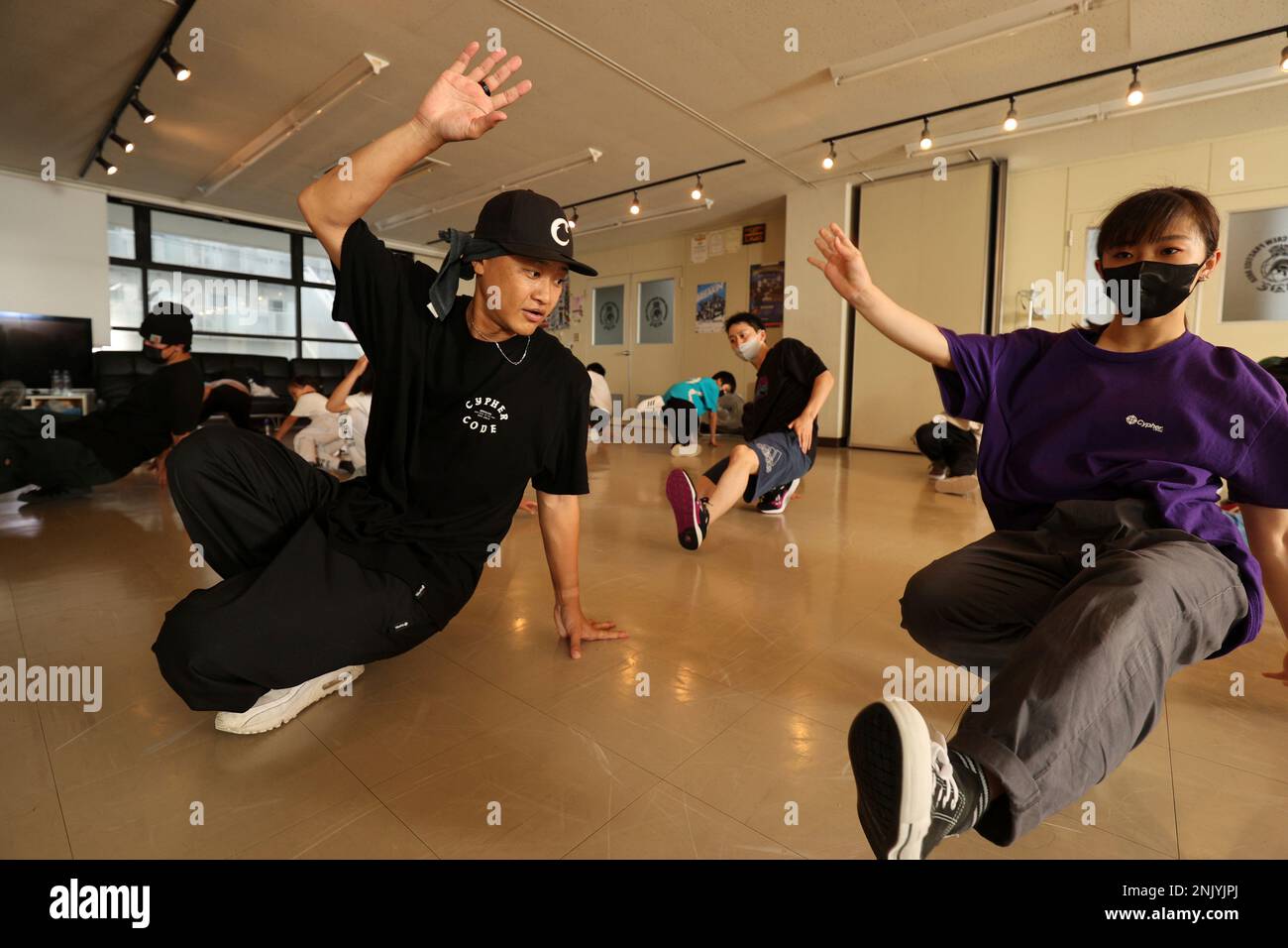 Japanese top breakdancer Katsuyuki Ishikawa (L), wearing a cap ...