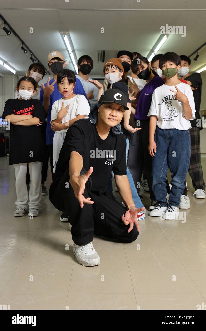 Japanese top breakdancer Katsuyuki Ishikawa (front) poses with students ...
