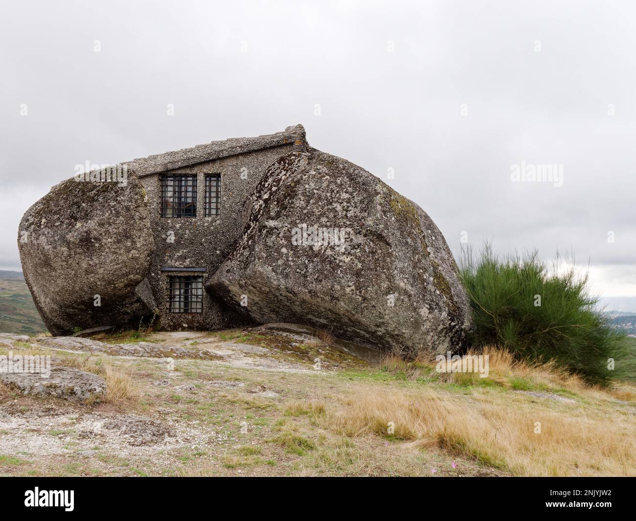 Boulder house or Casa do Penedo, a house built between huge rocks on ...