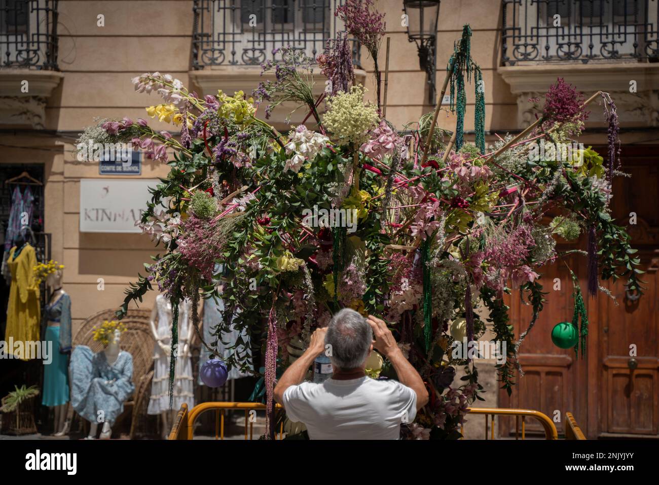 A man photographs one of the floral arrangements of the First ...