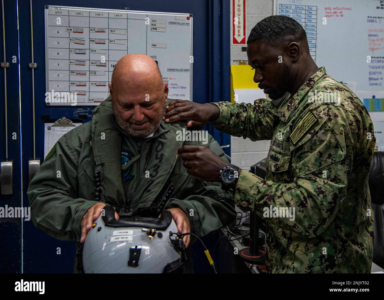 Aircrew Survival Equipmentman 1st Class Blake Taylor, right, assists ...