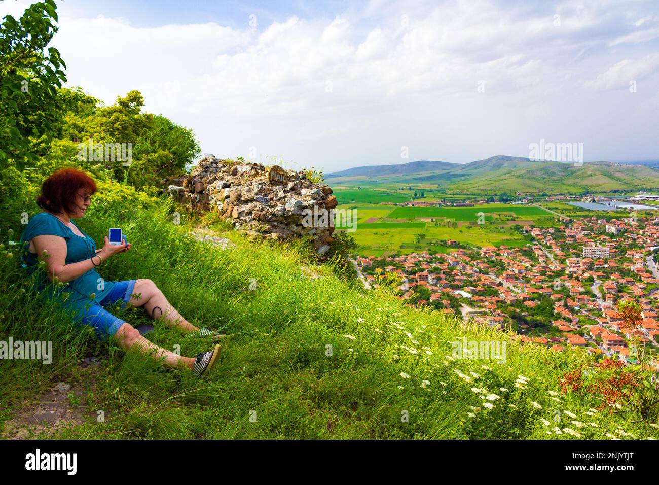 Senior woman relaxing on a meadow above Krichim town,Plovdiv district ...