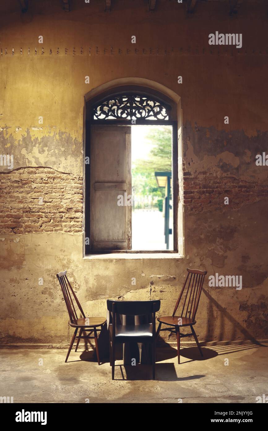 one table and three chairs are putting under the antique window in pop ...