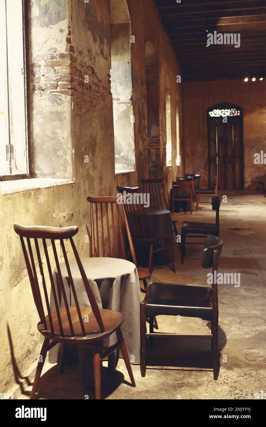 three table sets put by the wall under window for natural outside light ...