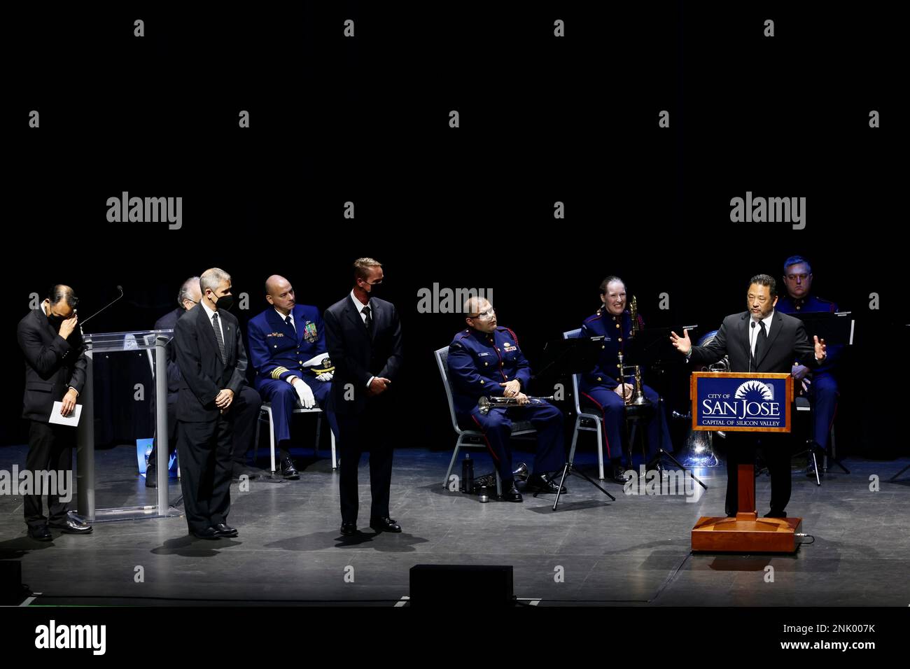 Stuart Mineta, left, wipes a tear, as his brother David Mineta delivers ...