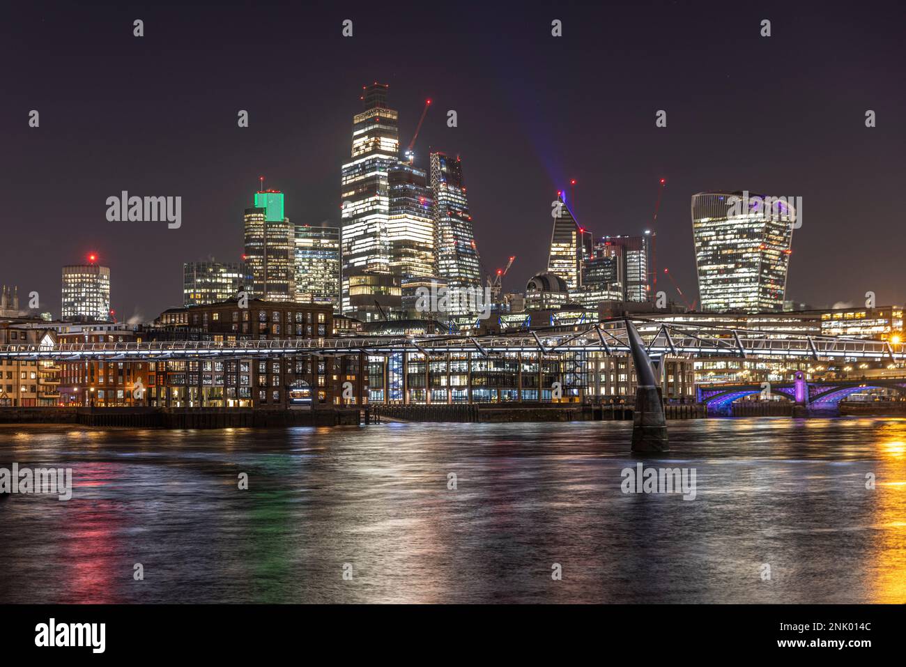 River Thames, the City and the Millennium Bridge at night, London ...
