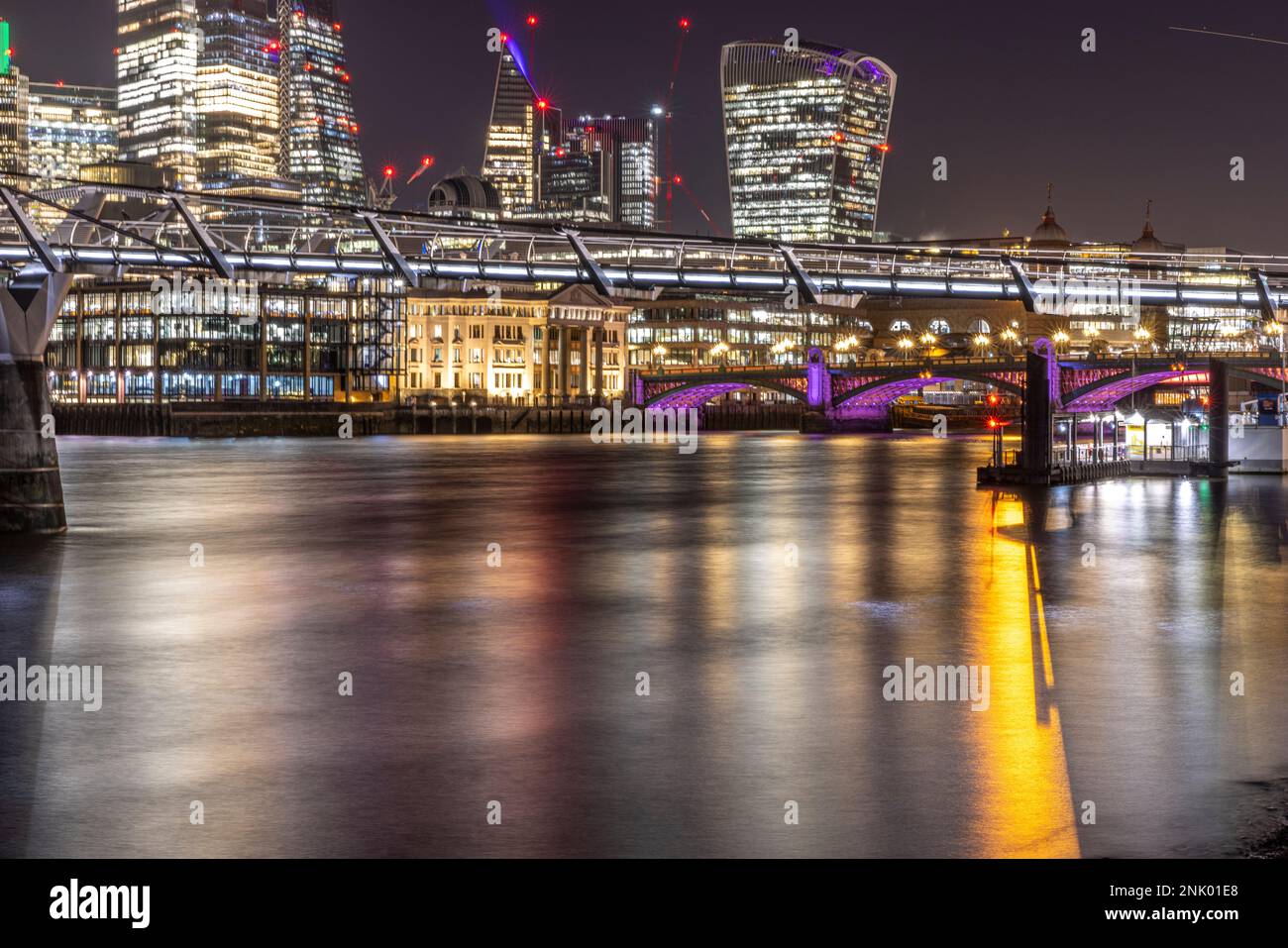 River Thames, the City and the Millennium Bridge at night, London ...