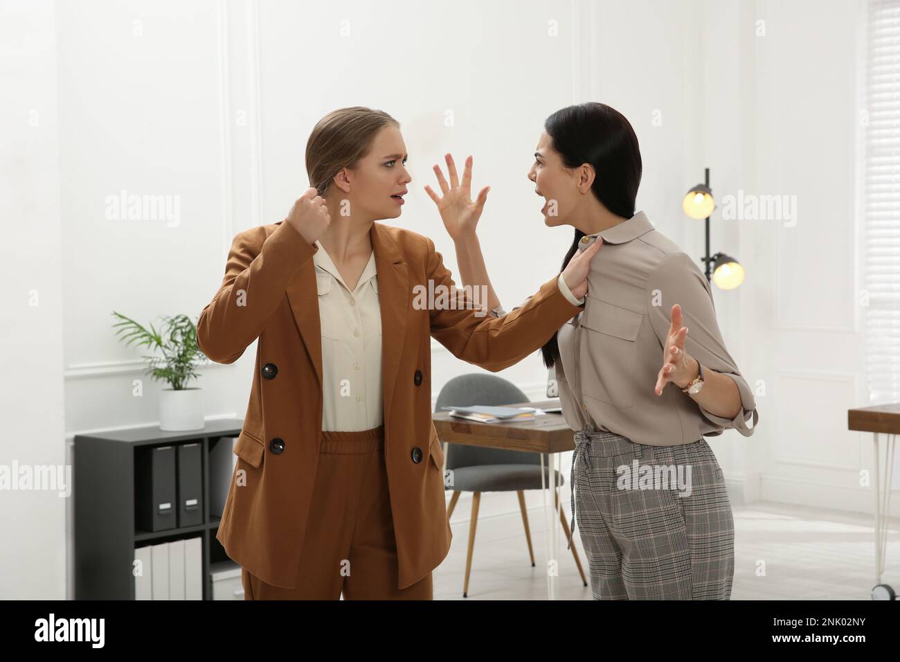 Emotional colleagues fighting in office. Workplace conflict Stock Photo ...