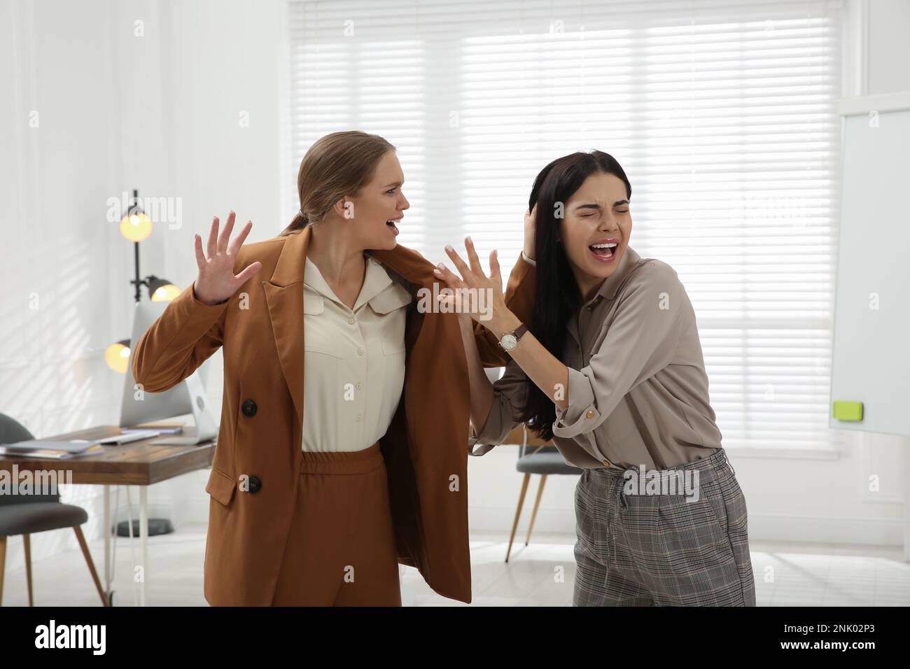Emotional colleagues fighting in office. Workplace conflict Stock Photo ...