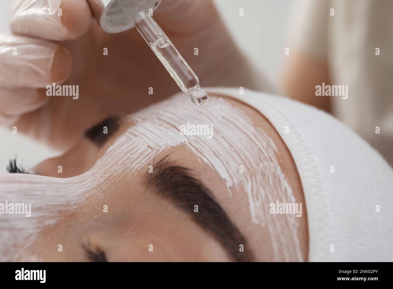 Young woman during face peeling procedure in salon, closeup Stock Photo ...