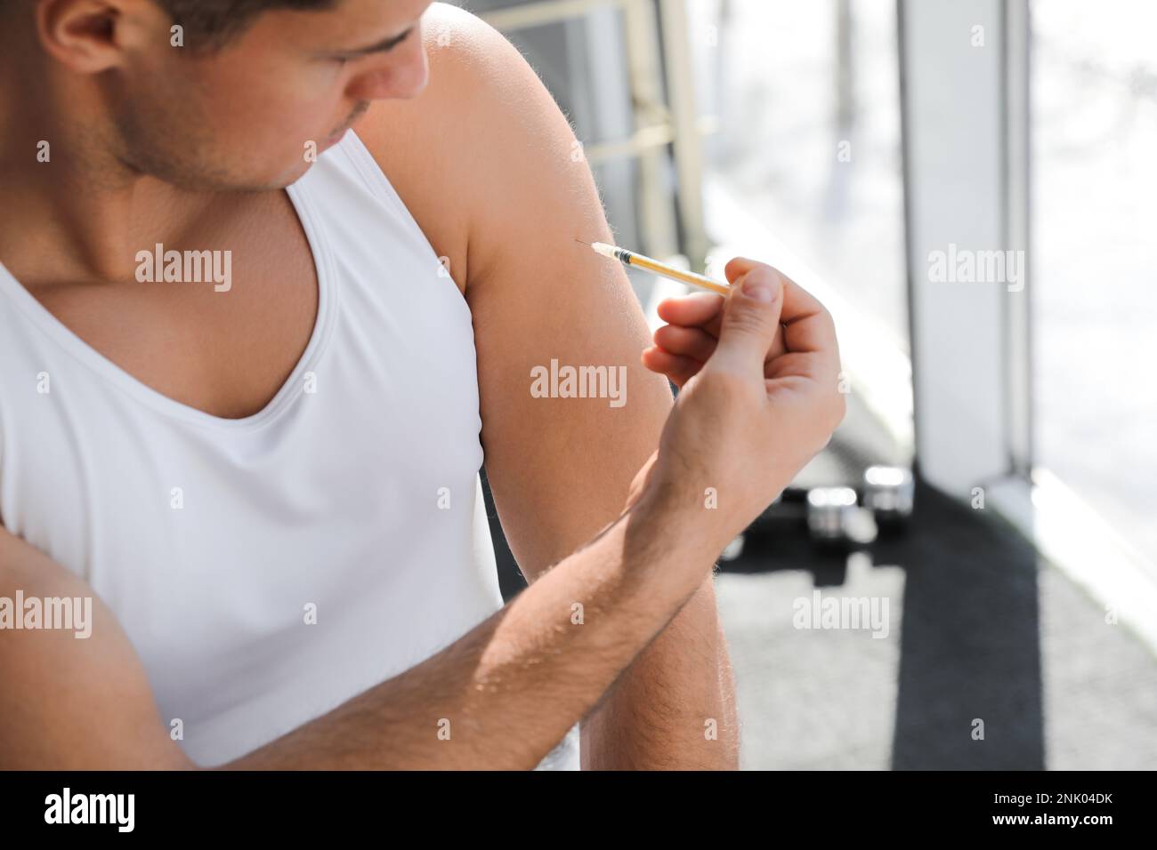 Sportsman injecting himself in gym, closeup. Doping concept Stock Photo ...