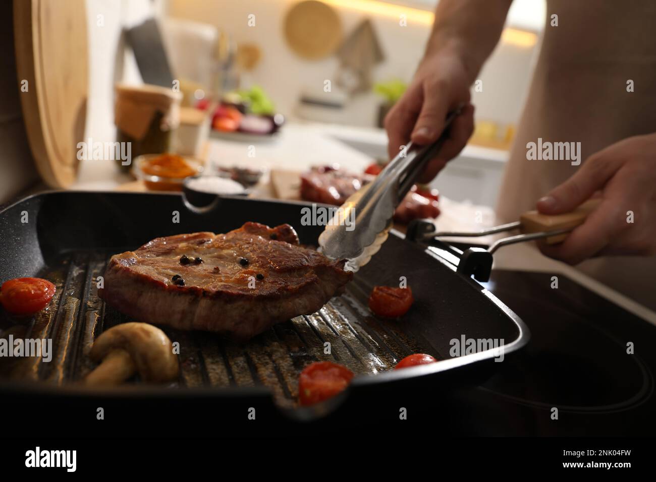 Man frying meat in pan hi-res stock photography and images - Alamy