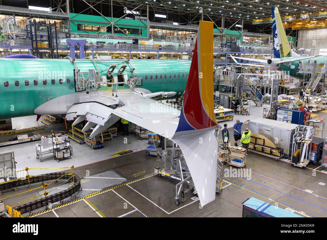 Boeing employees work on the 737 MAX on the final assembly line at ...
