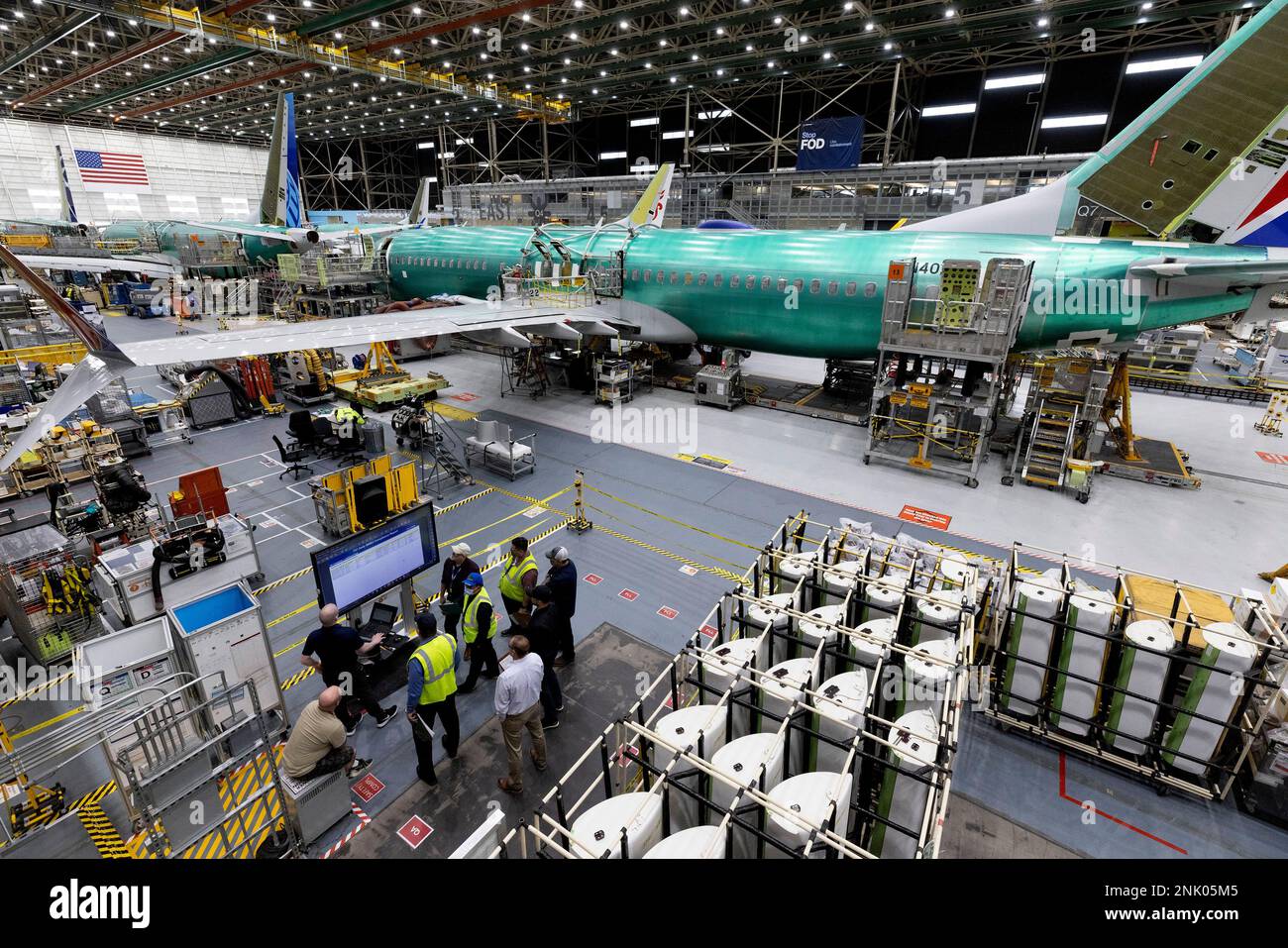 Boeing employees work on the 737 MAX on the final assembly line at ...