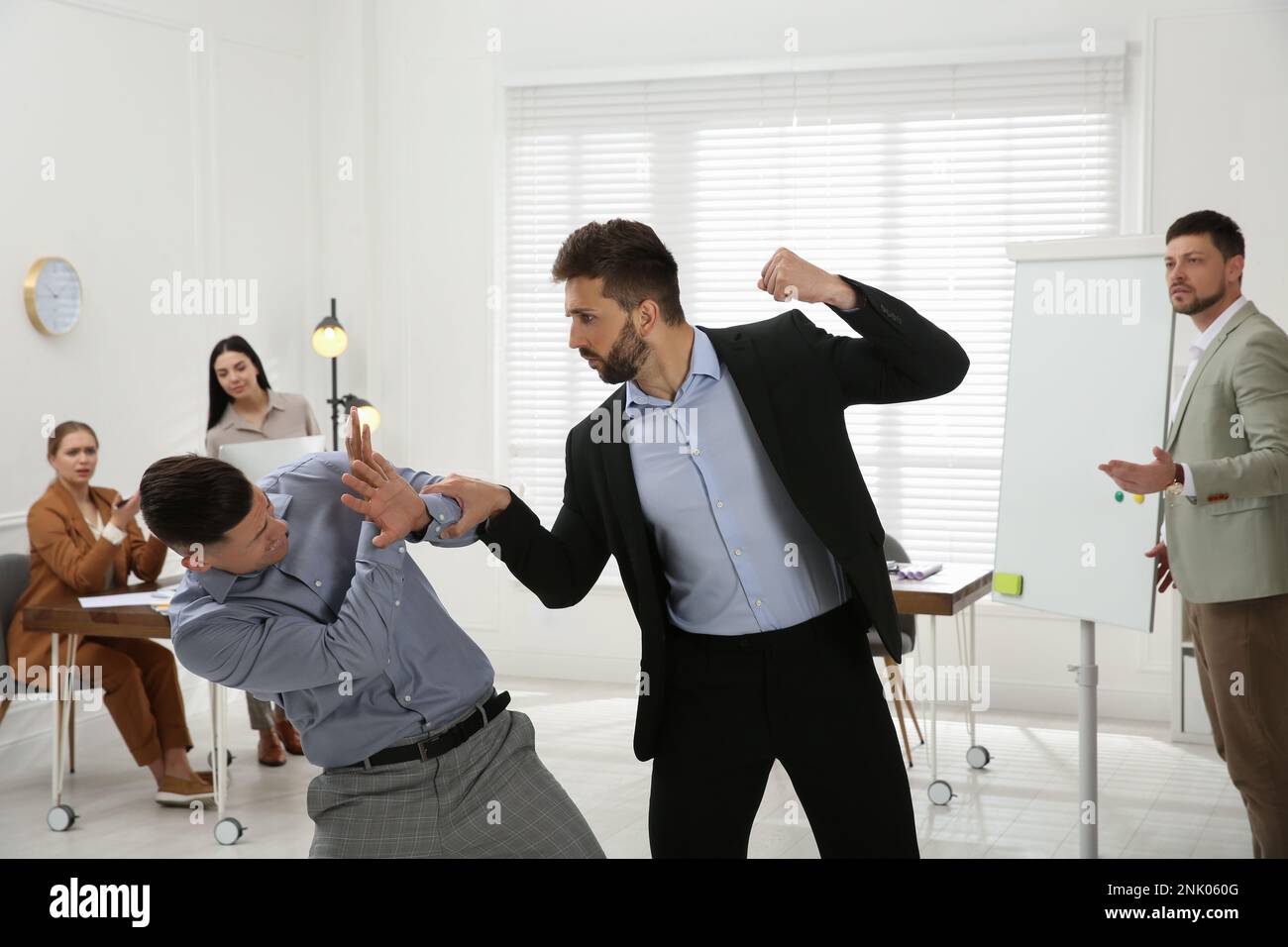 Emotional colleagues fighting in office. Workplace conflict Stock Photo ...