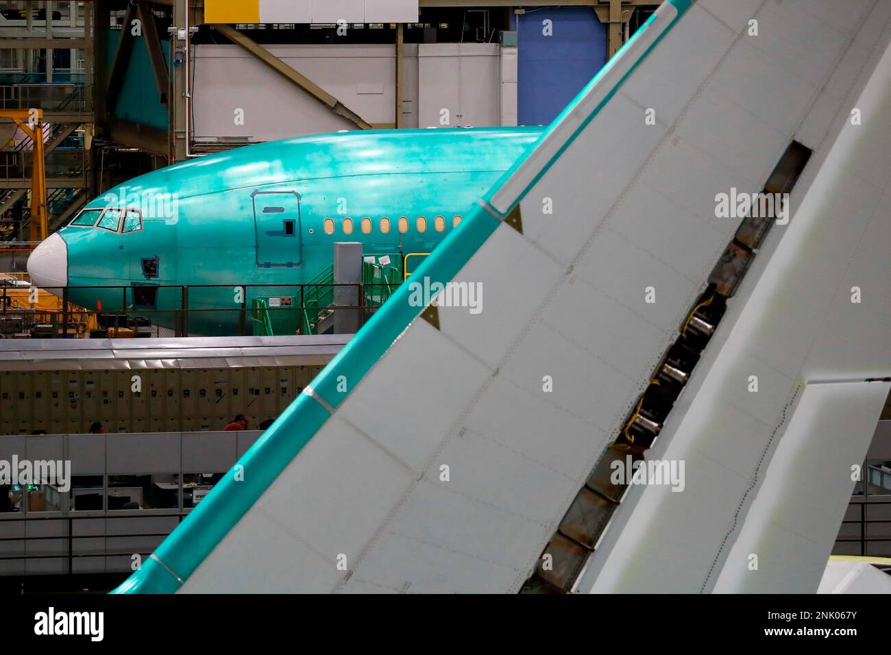 A 777X is seen behind the tail of a 777 freighter at Boeing's Everett ...