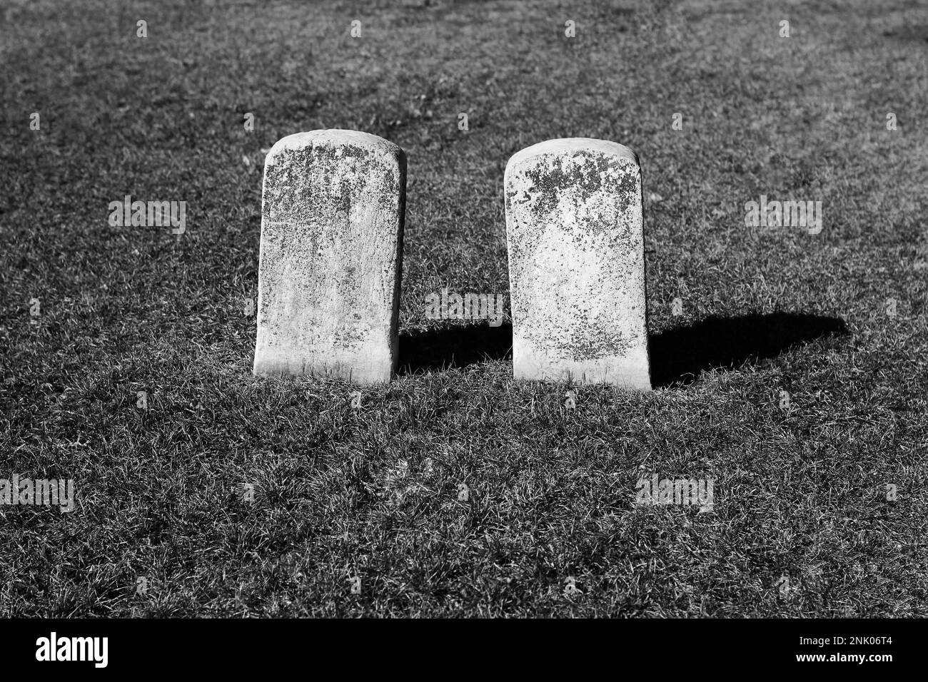 A worn and weathered old tombstone with a blank epitaph and room for ...