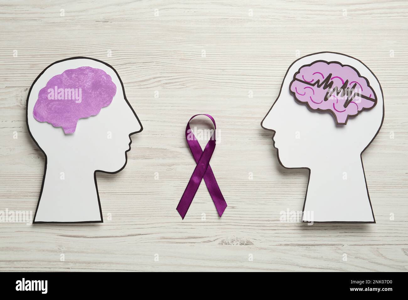 Human head cutouts with different brains and purple ribbon on white ...