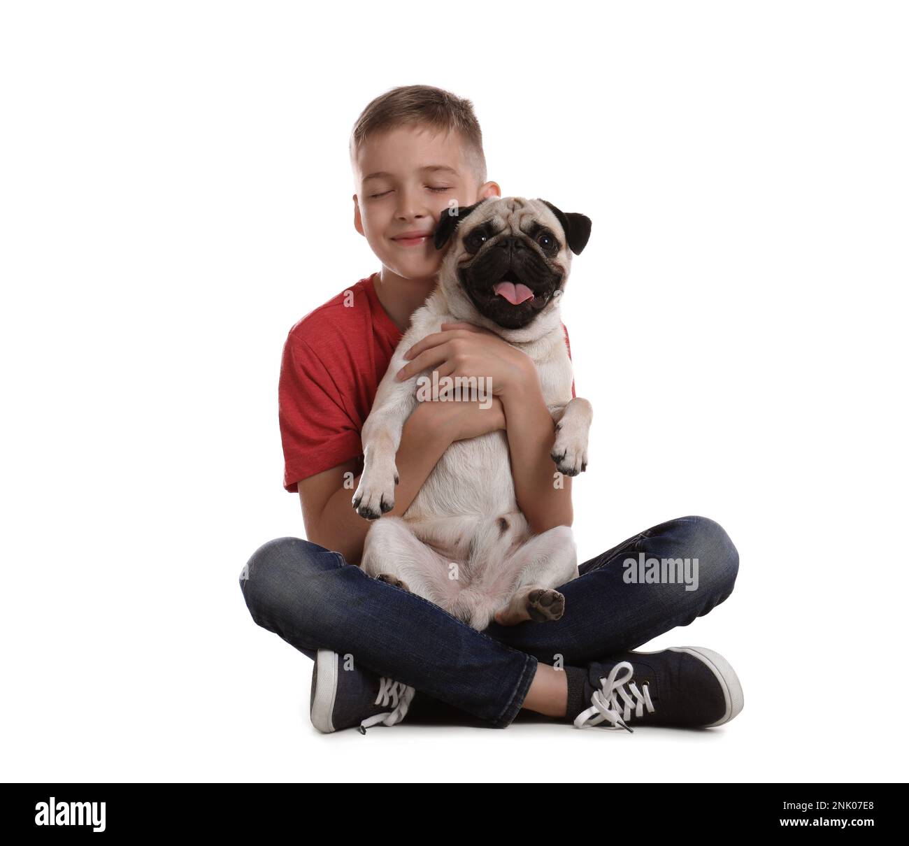 Boy hugging his cute pug on white background Stock Photo - Alamy