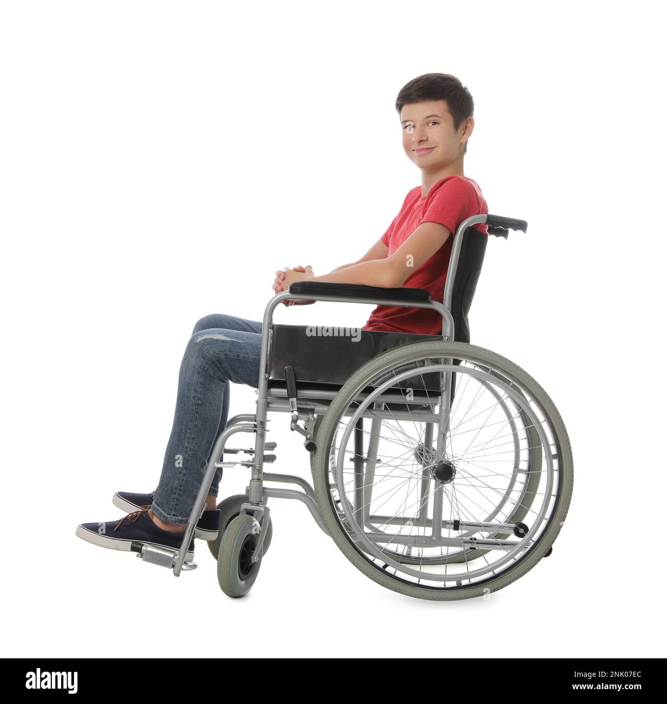 Teen boy in wheelchair on white background Stock Photo - Alamy