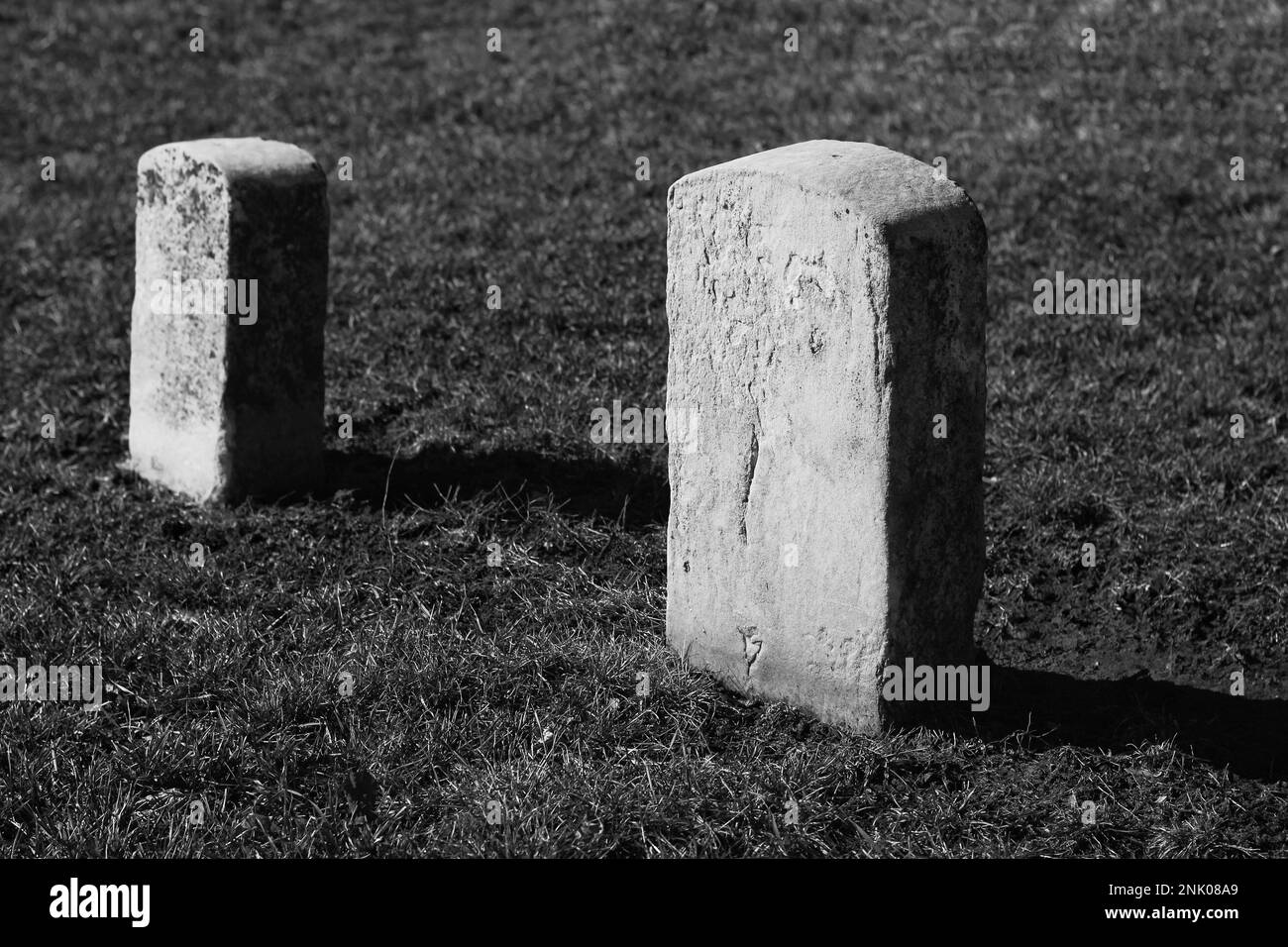 A worn and weathered old tombstone with a blank epitaph and room for ...