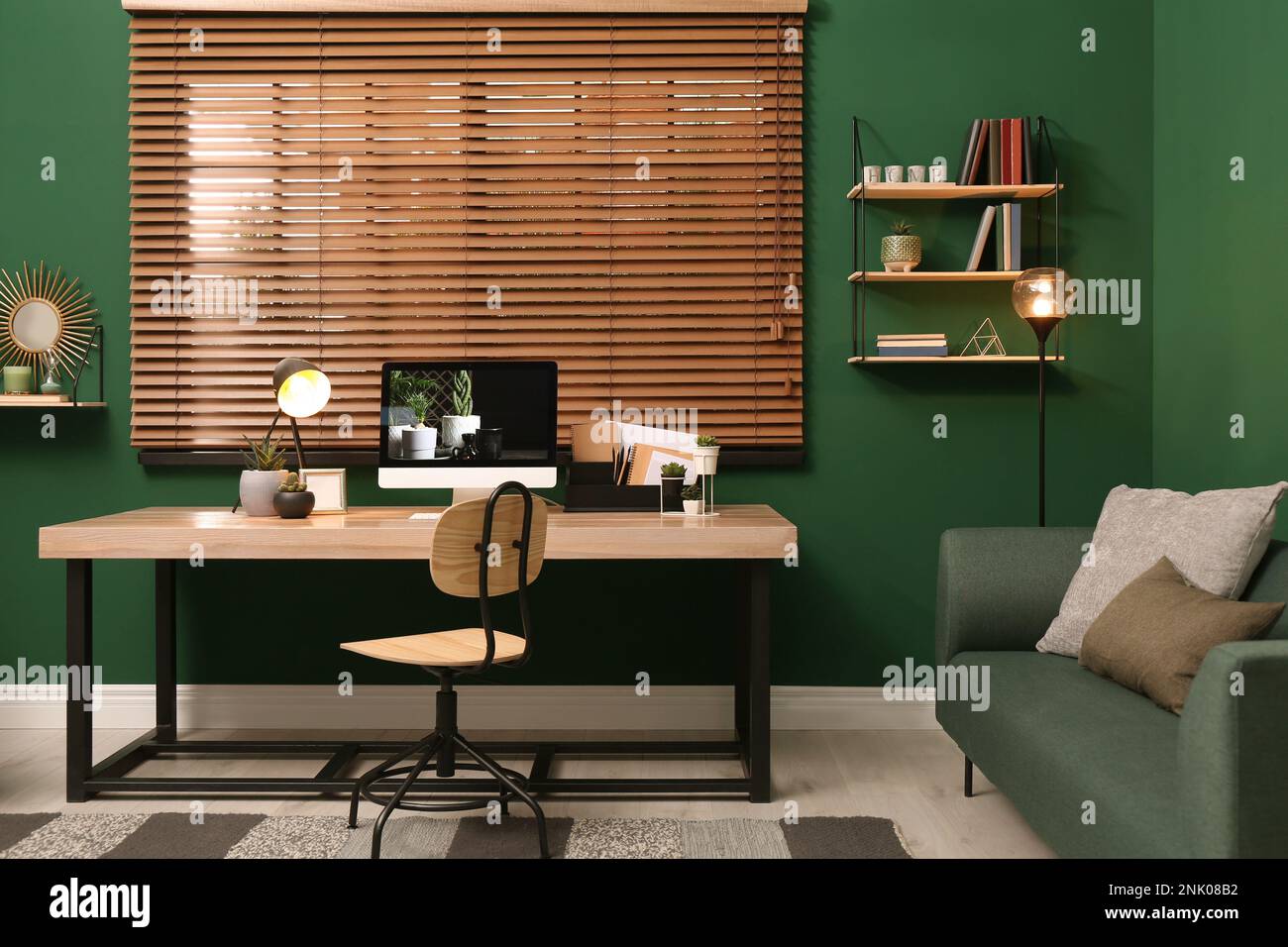 Comfortable workplace with modern computer near window in room ...