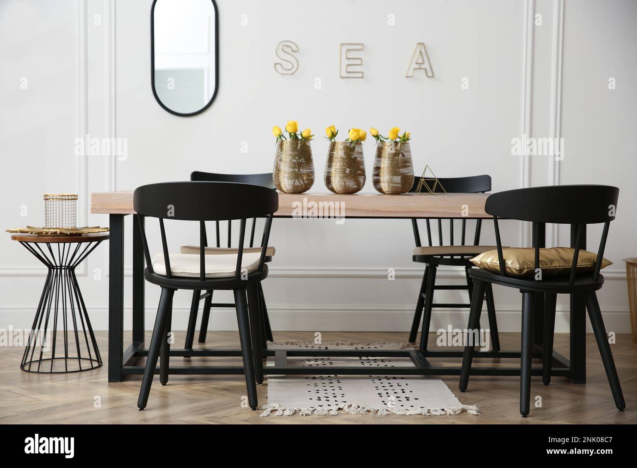 Stylish wooden dining table and chairs in room. Interior design Stock ...