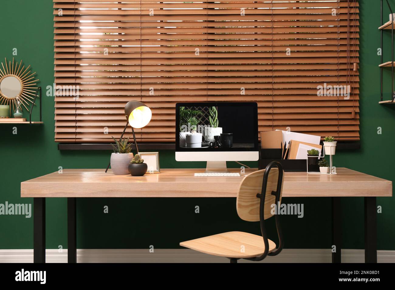 Comfortable workplace with modern computer near window in room ...