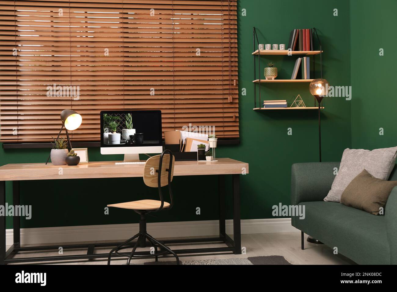 Comfortable workplace with modern computer near window in room ...