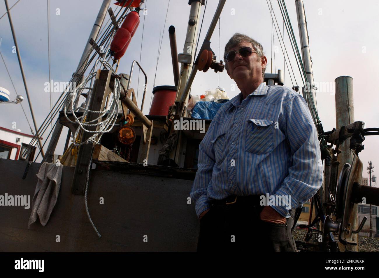 Mike Fontes, who is part Portuguese, stands in the stern of his fishing ...