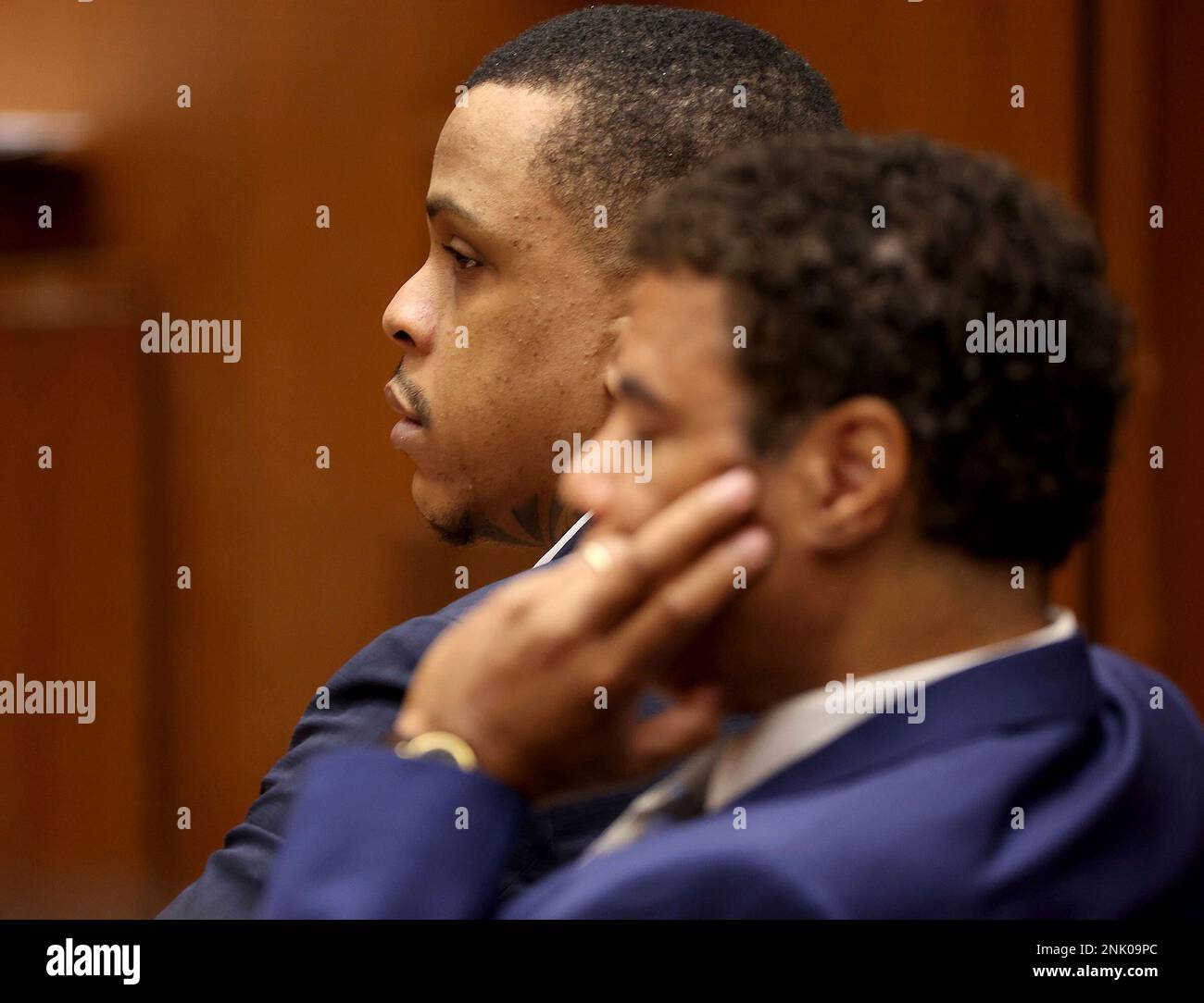 Defendant Eric Holder and his attorney Aaron Jansen, right, listen ...