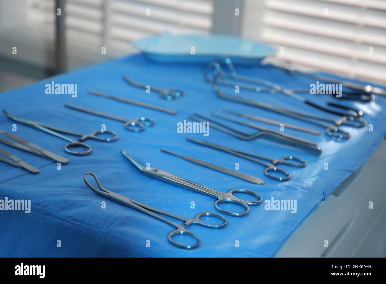 Different surgical instruments on blue table indoors Stock Photo - Alamy