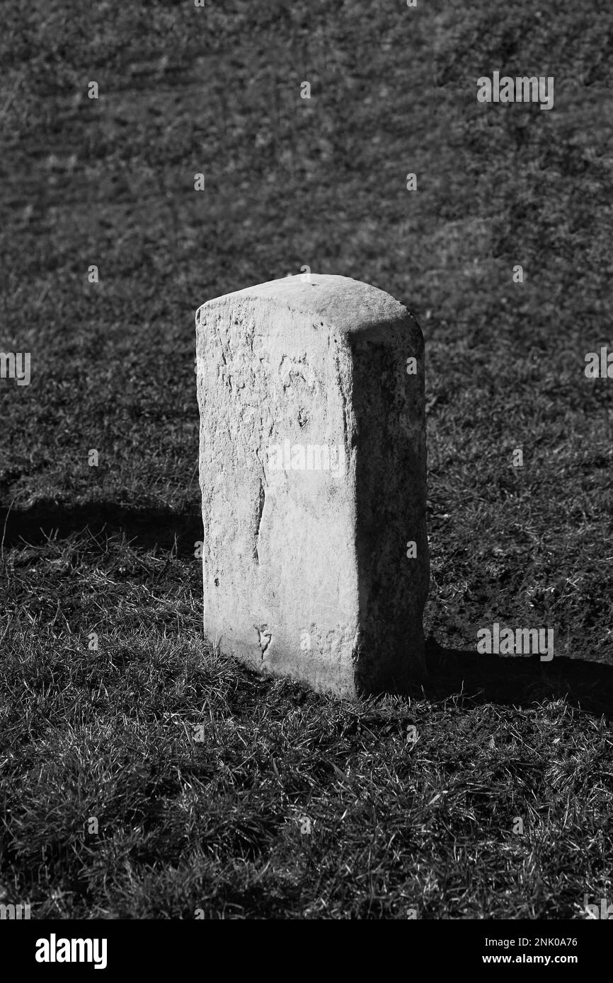 A worn and weathered old tombstone with a blank epitaph and room for ...