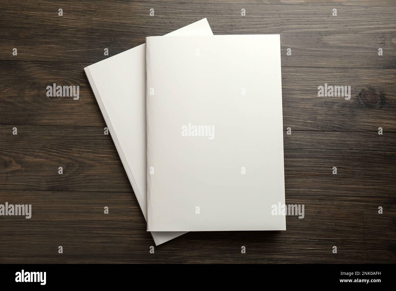 Blank paper brochures on wooden table, top view. Mockup for design ...