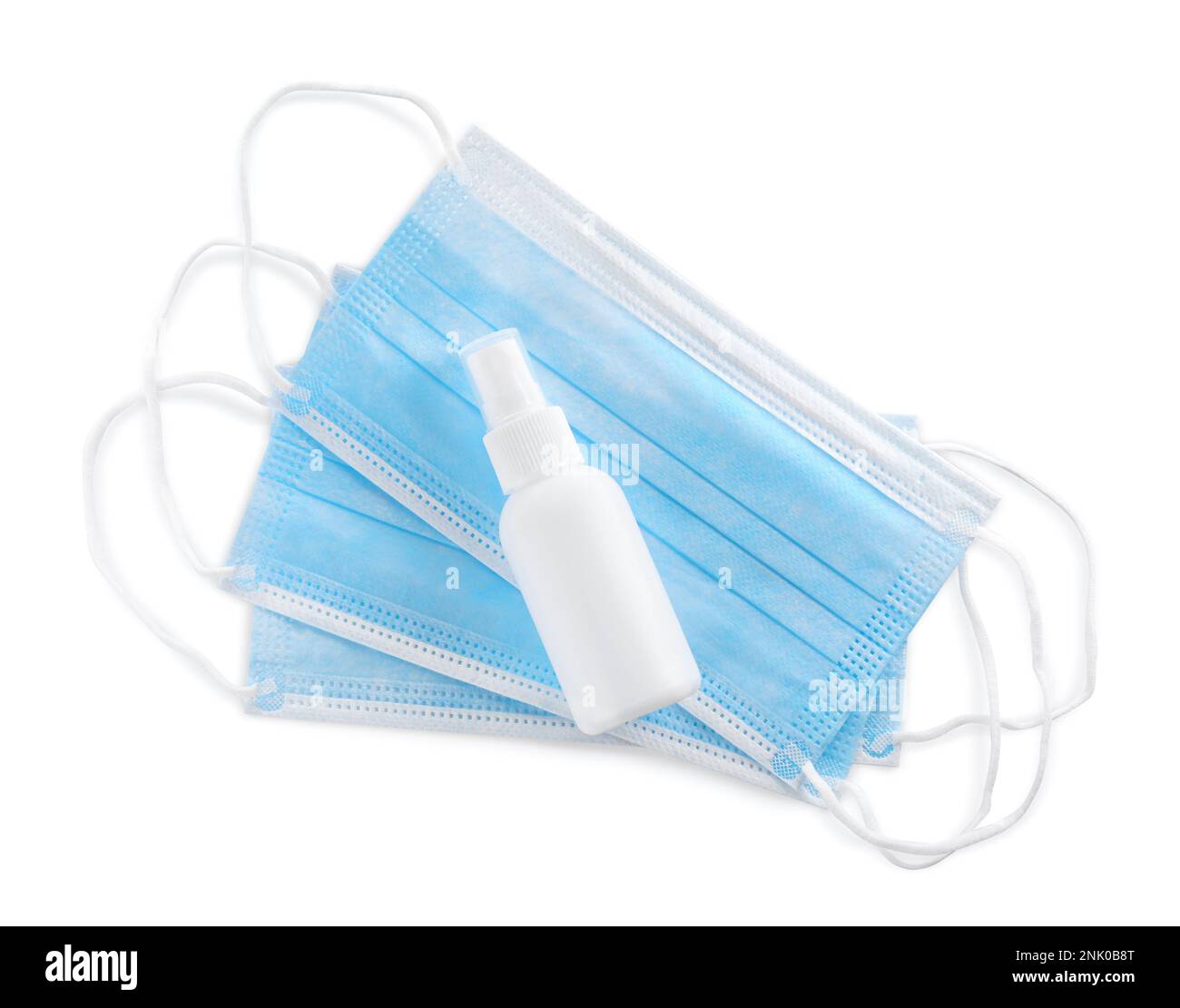 Protective masks and antiseptic on white background, top view Stock ...