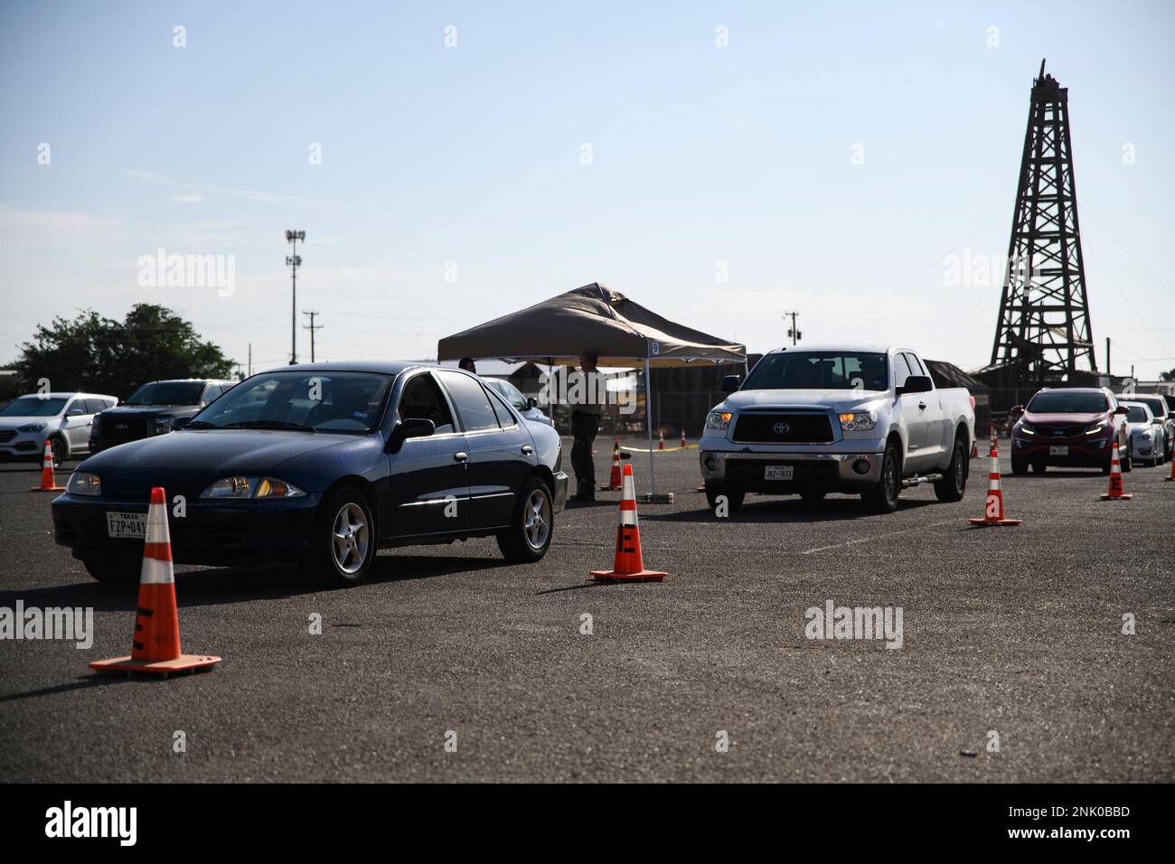 Cars line up outside Barn E for drinking water as the City of Odessa ...