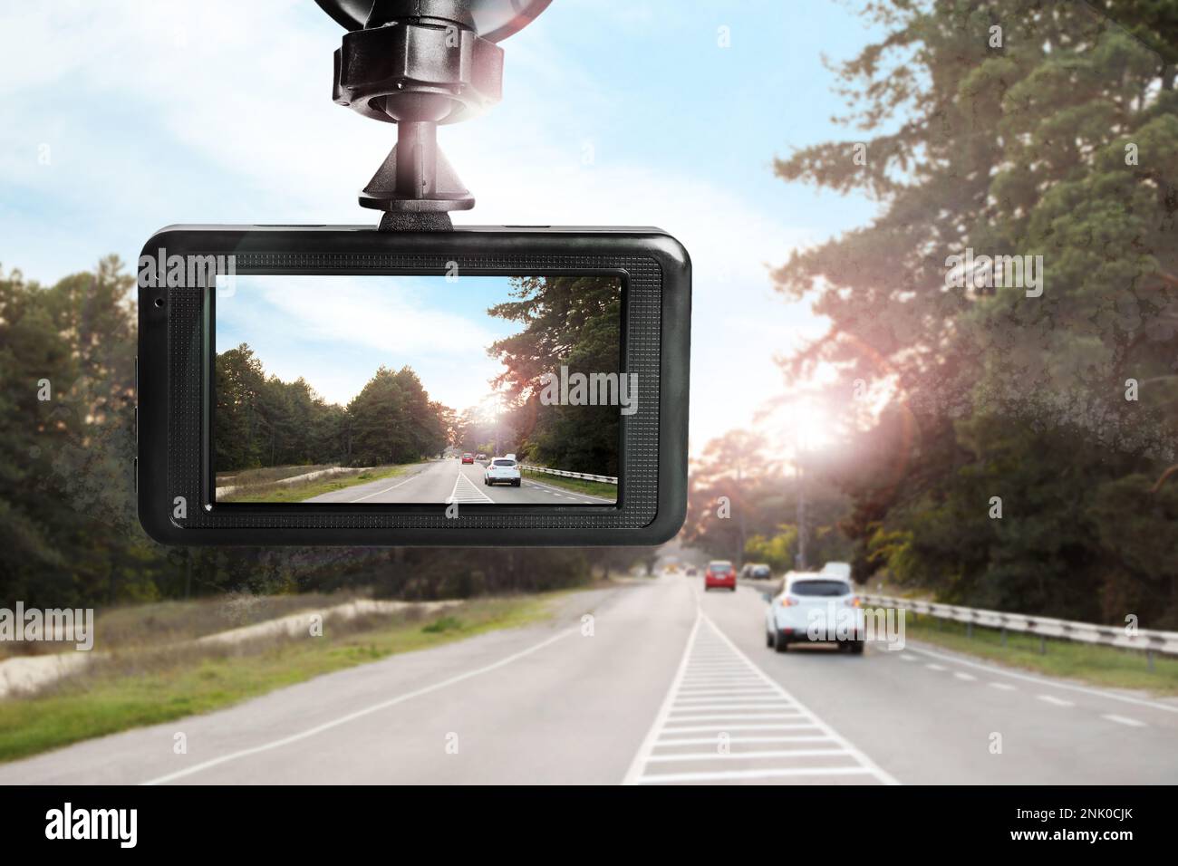 Modern dashboard camera mounted in car, view of road during driving ...