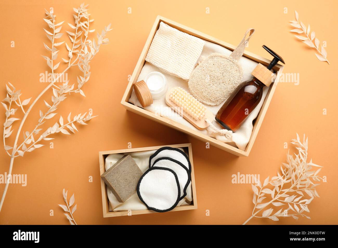 Eco friendly products in crates on pale orange background, flat lay ...