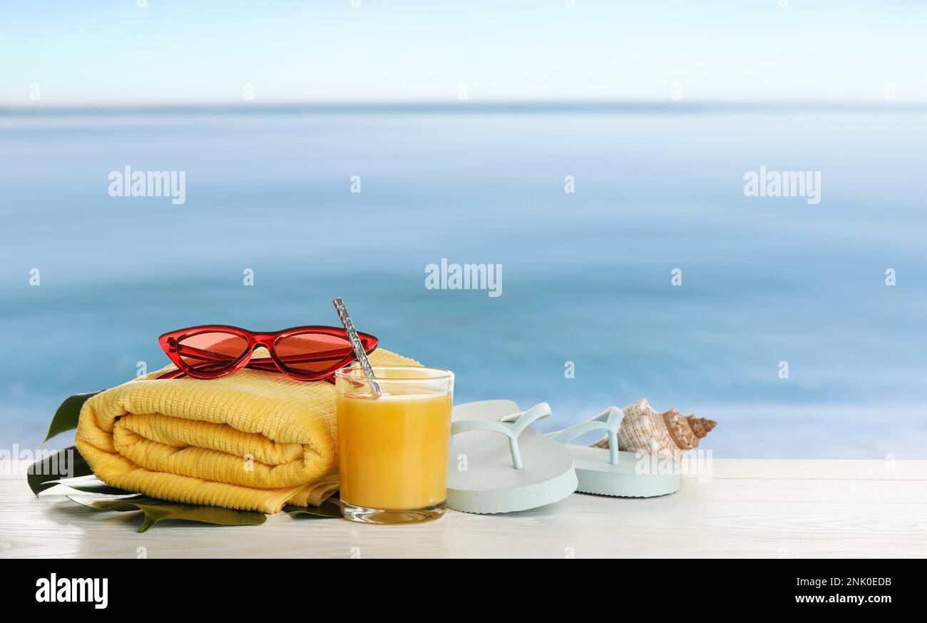 Different beach objects on wooden surface near sea Stock Photo - Alamy