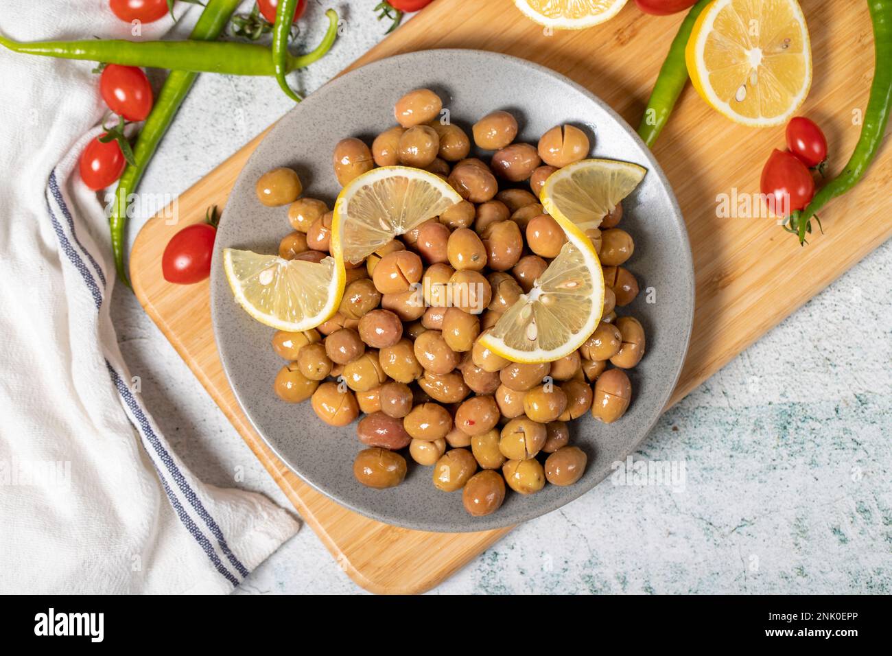 Scratched green olives. Brined scratched green olives on a wood serving ...