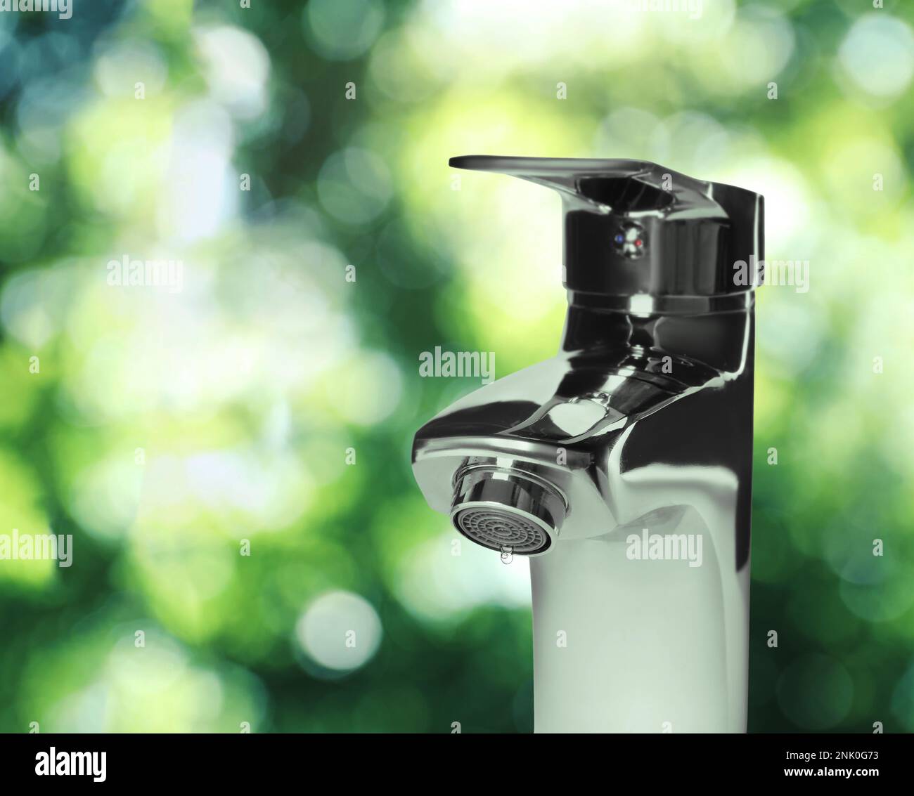 Water drop flowing from tap outdoors on sunny day, bokeh effect Stock ...