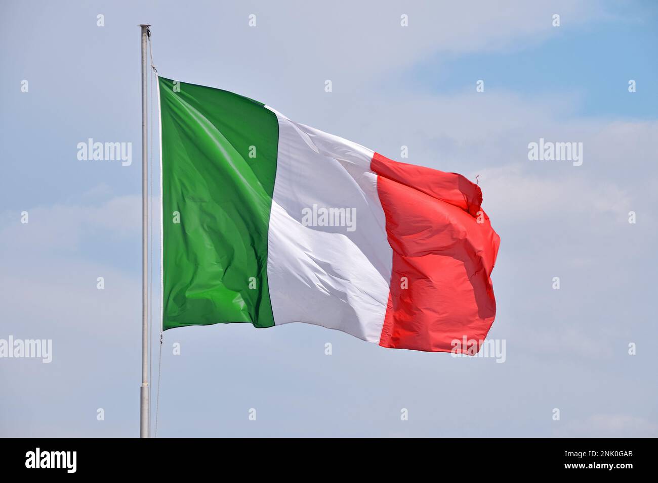 National flag of Italy flying and waving in the wind on flagstaff over ...