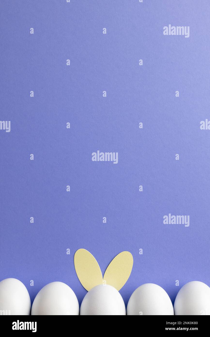 Image of row of white easter eggs with bunny ears and copy space on ...