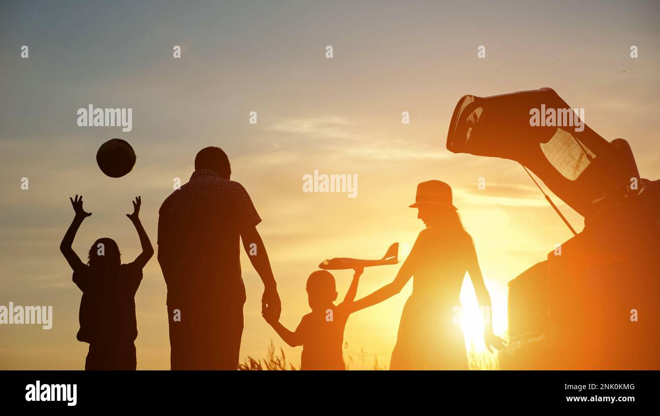 Family standing near car spends time together at back sunset Stock ...