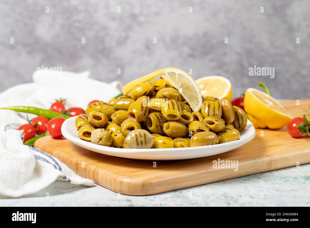 Grilled olives. Tasty Green grilled olives in the plate. Healthy food ...