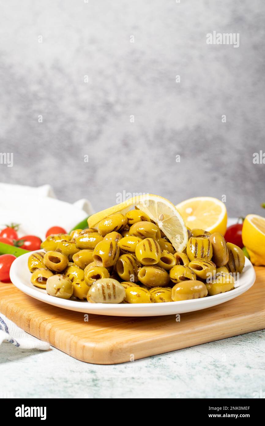 Grilled olives. Tasty Green grilled olives in the plate. Healthy food ...