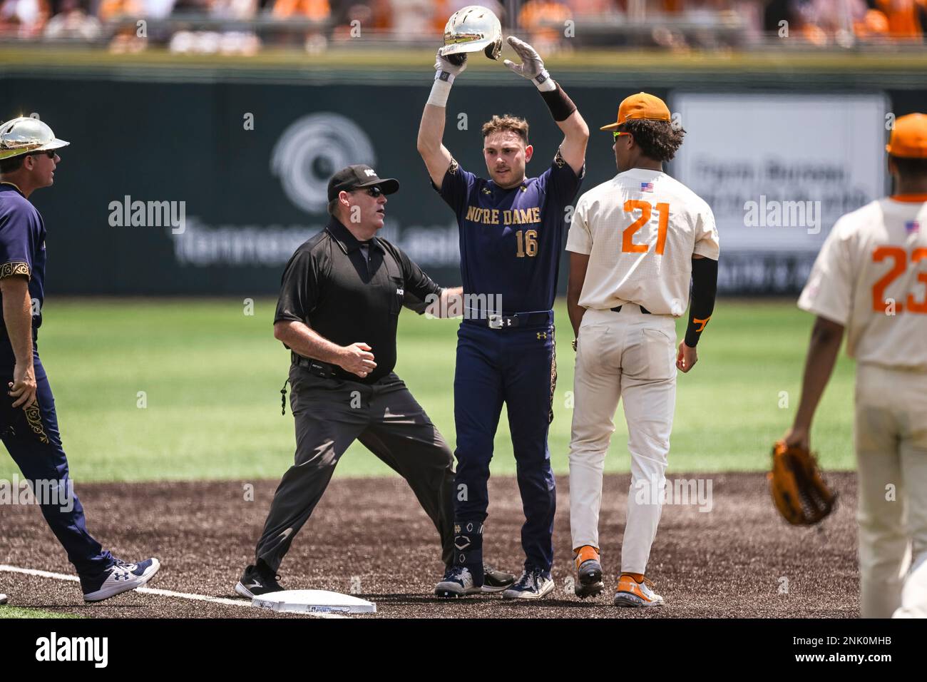 KNOXVILLE, TN - JUNE 12: Umpire Greg Harmon steps in to break up Notre Dame infielder Jared ...