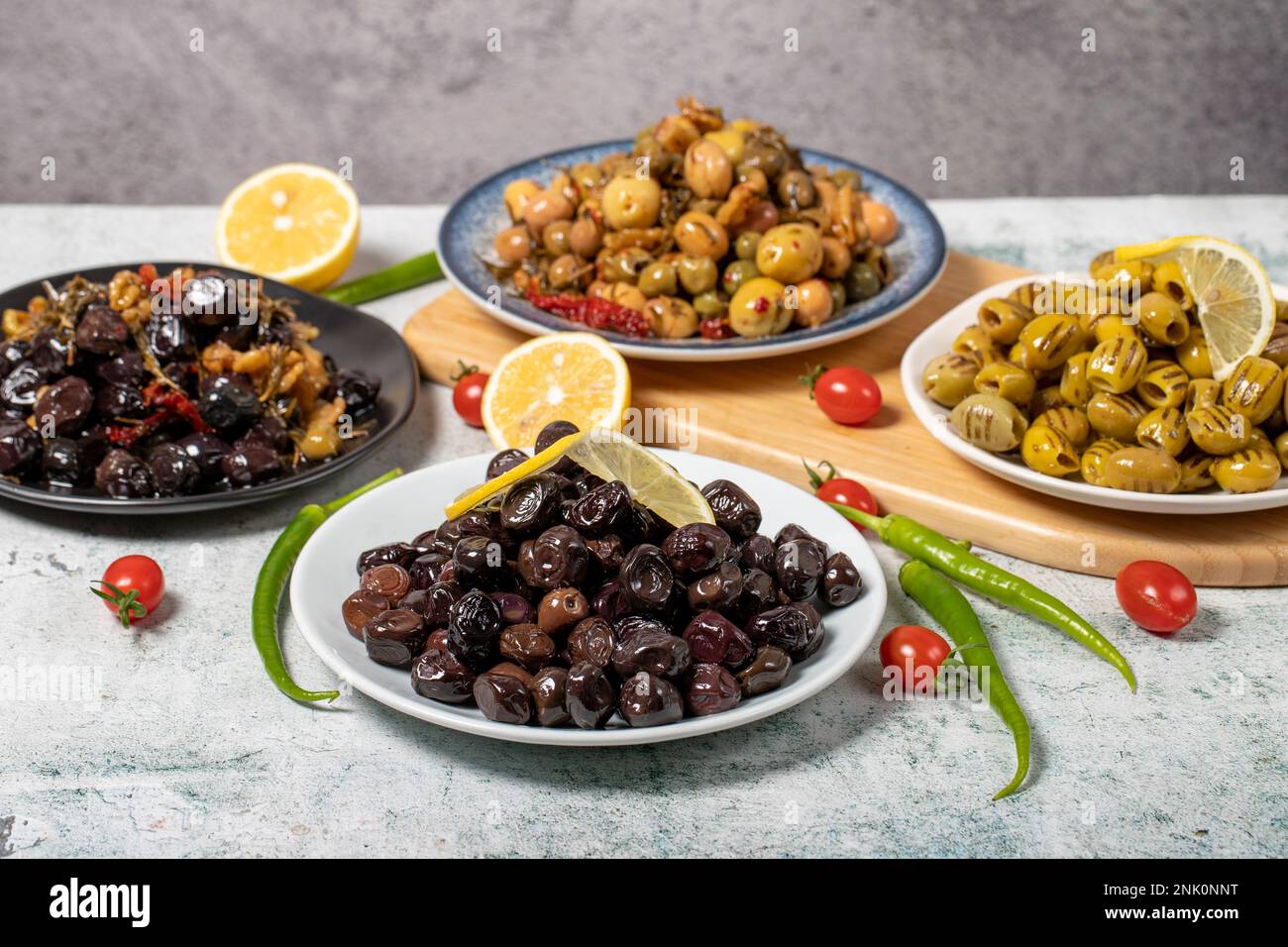 Olive varieties. Assortment of black and green olives on plate on gray ...