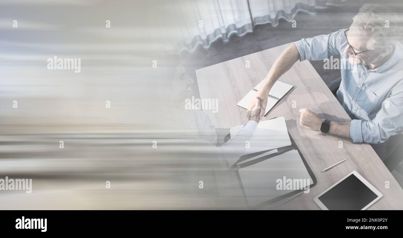 Composition of two happy diverse businessmen shaking hands with motion ...